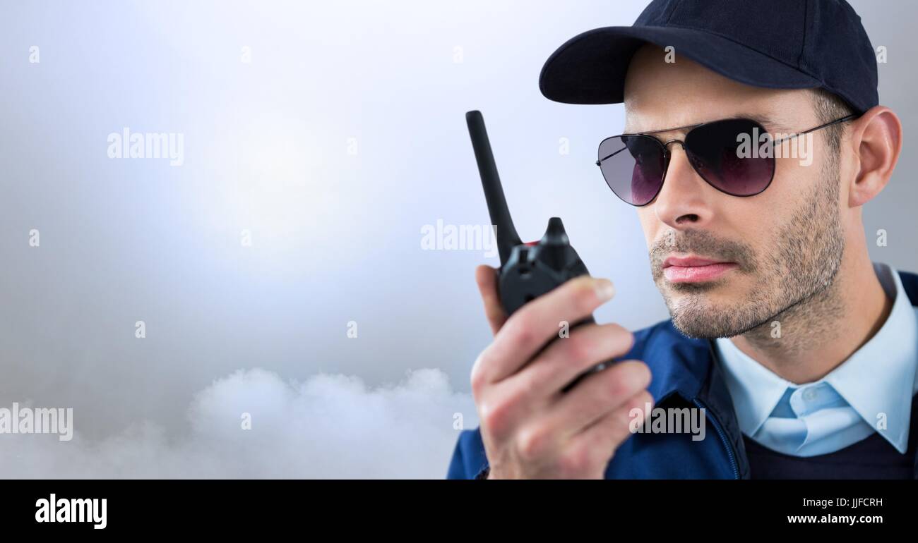 Digital composite of Security man outside with bright background clouds ...
