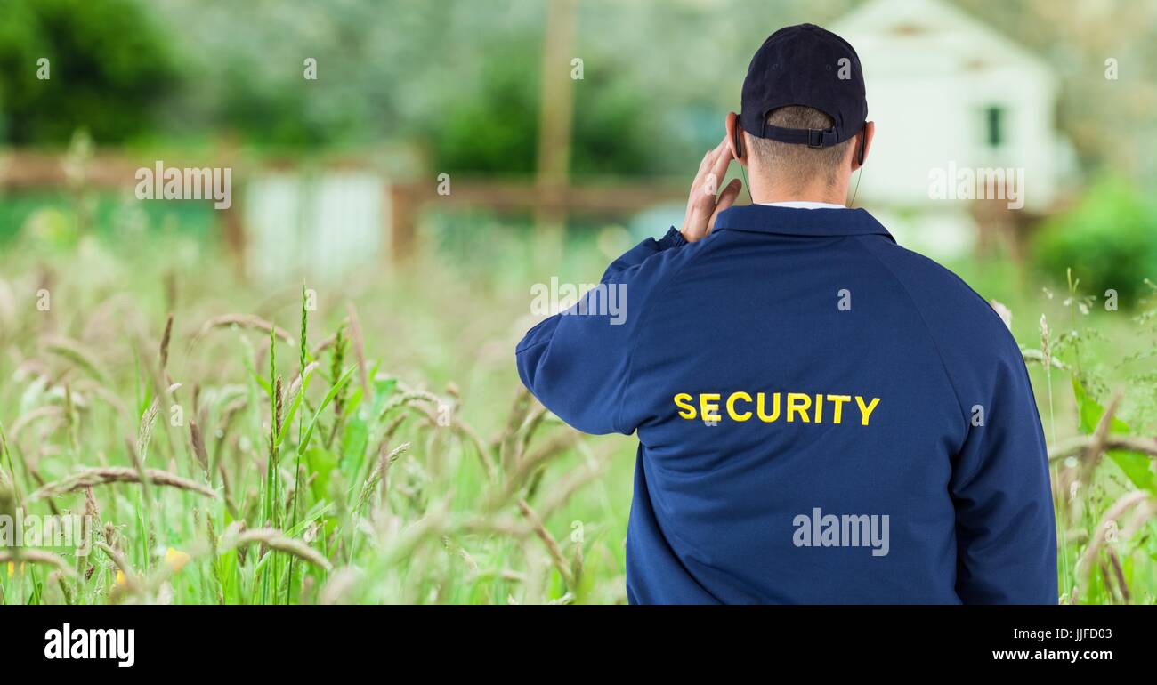 Digital composite of Rear view of security guard on field Stock Photo ...