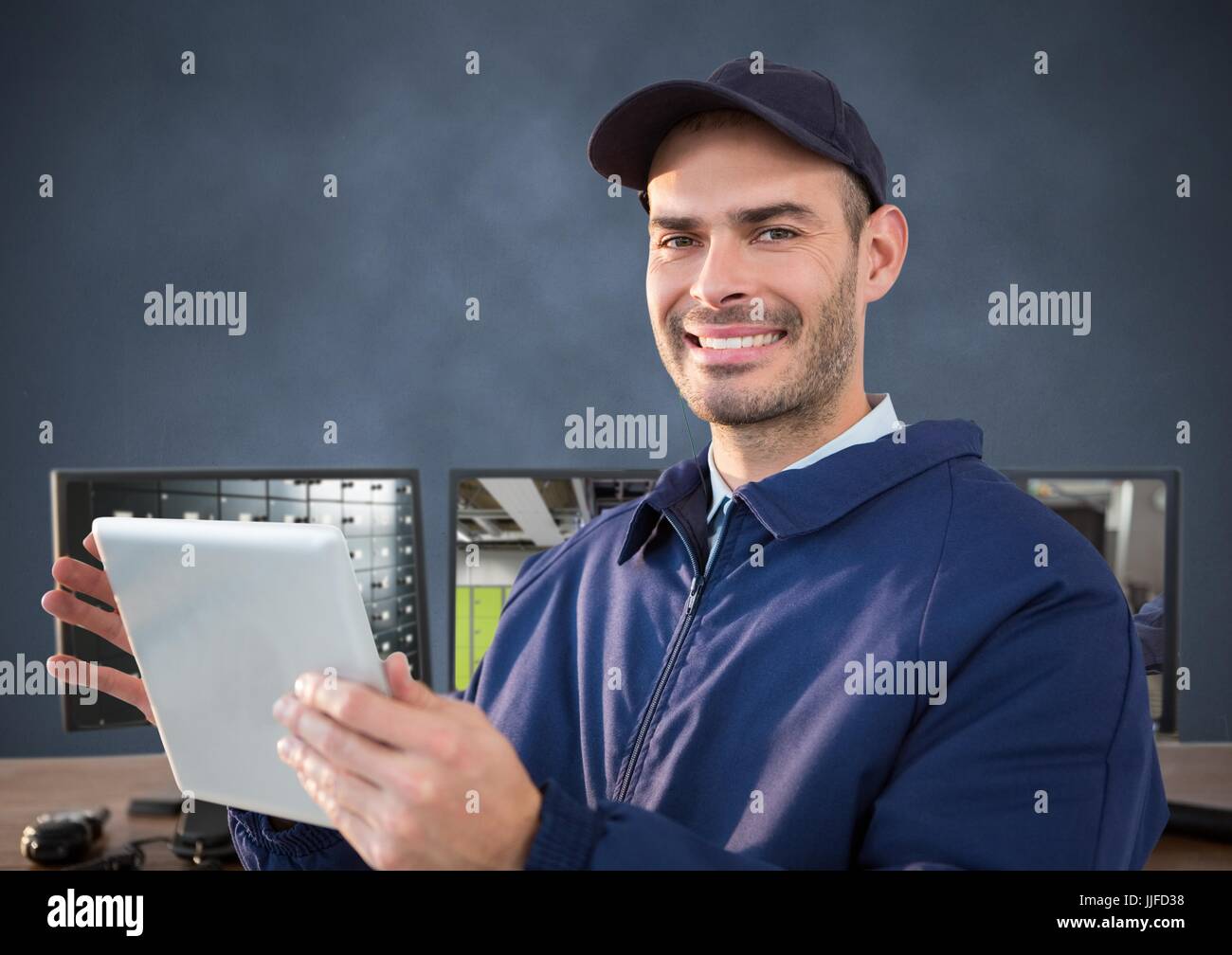 Digital composite of security guard smiling in front of the computers ...