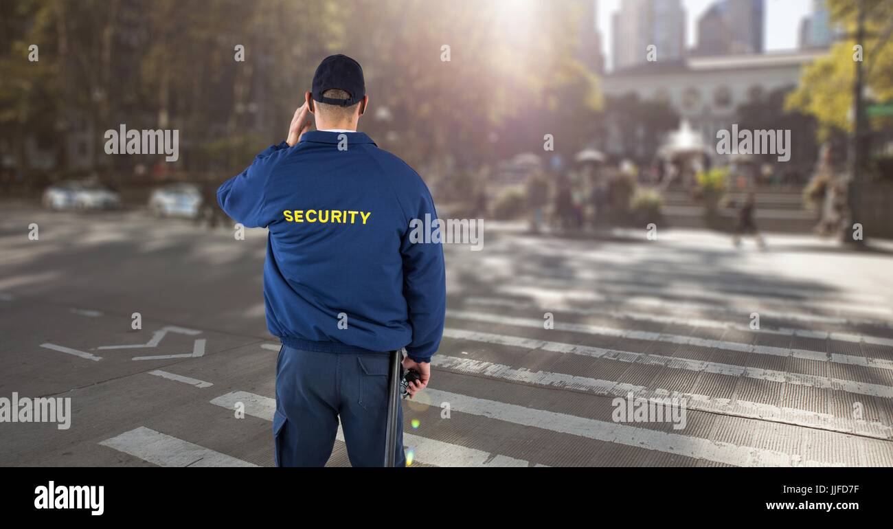 Digital composite of Rear view of security guard standing on road in ...