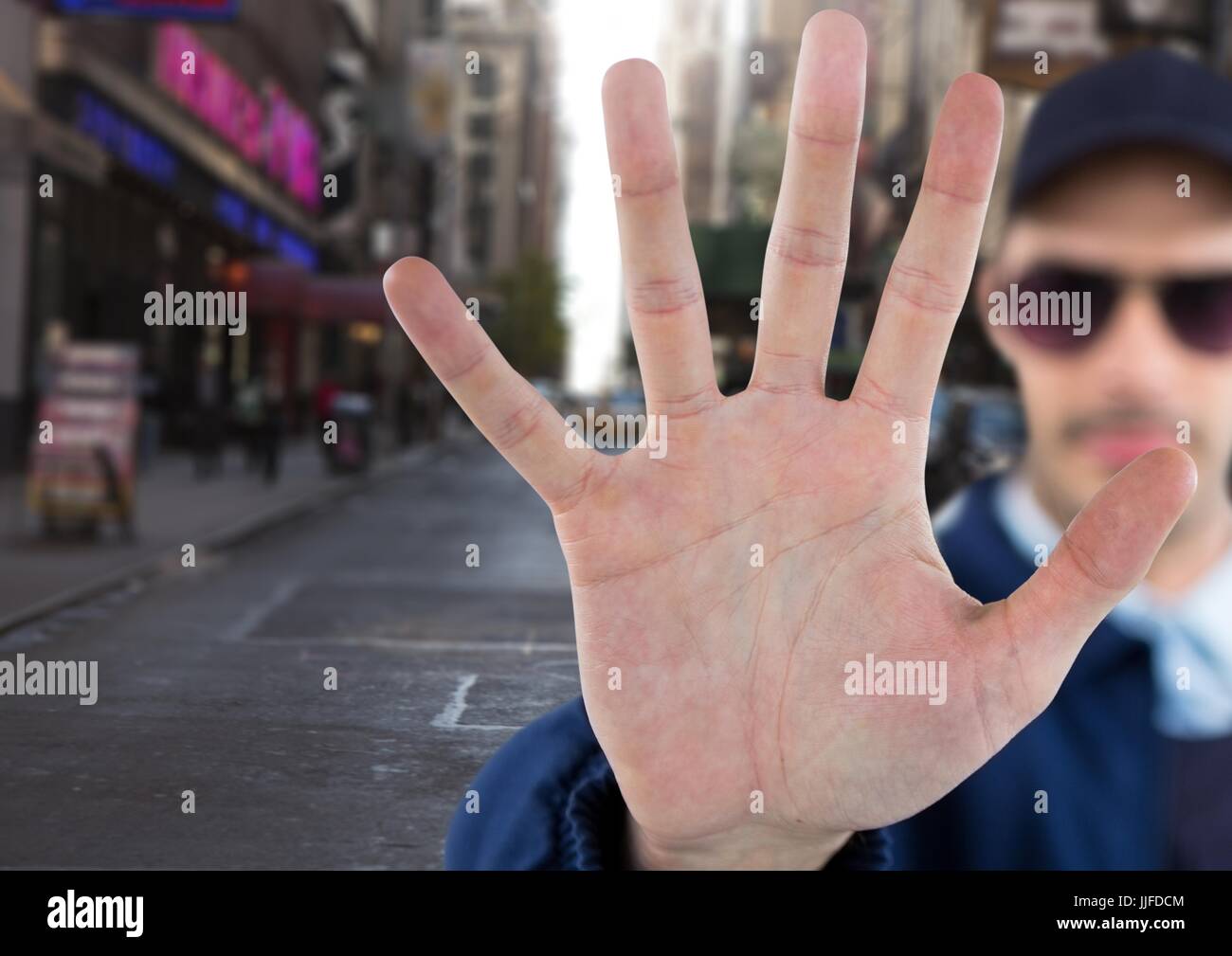 Digital composite of Man with stop hand gesture on street Stock Photo ...