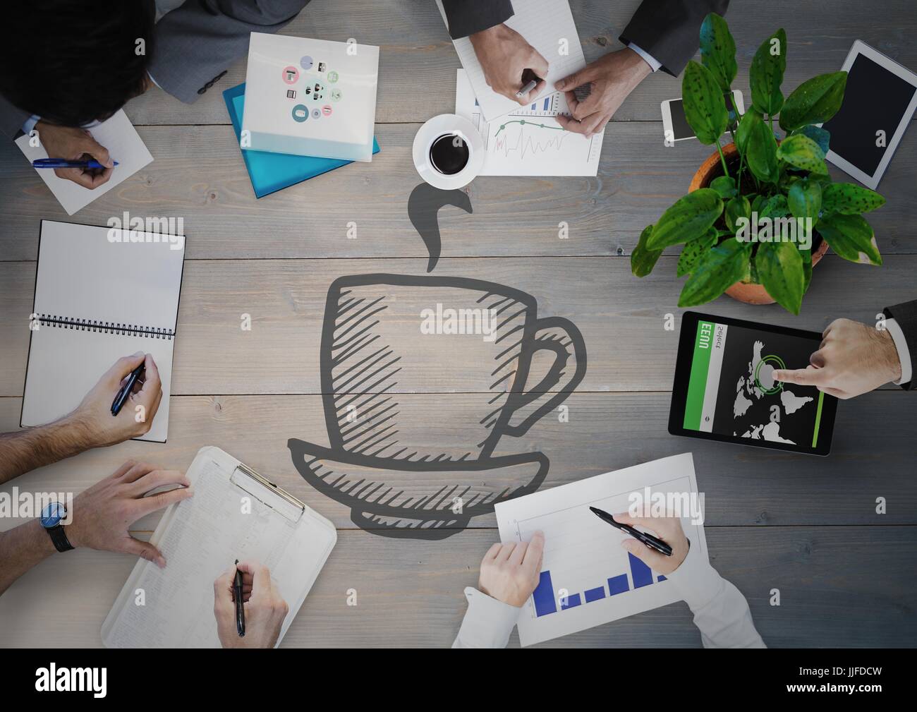 Digital composite of Overhead of hands writing with grey wood panel and ...