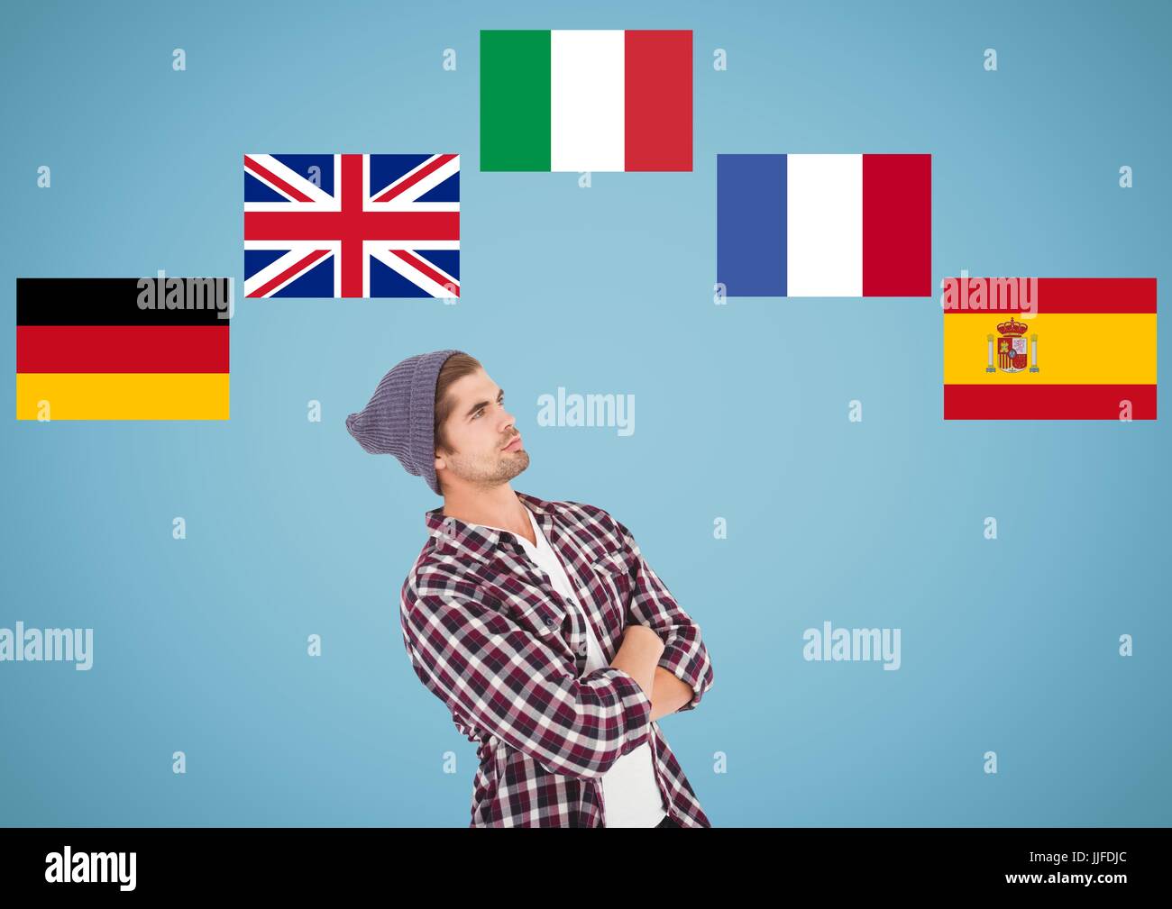Digital composite of main language flags around young man thinking ...