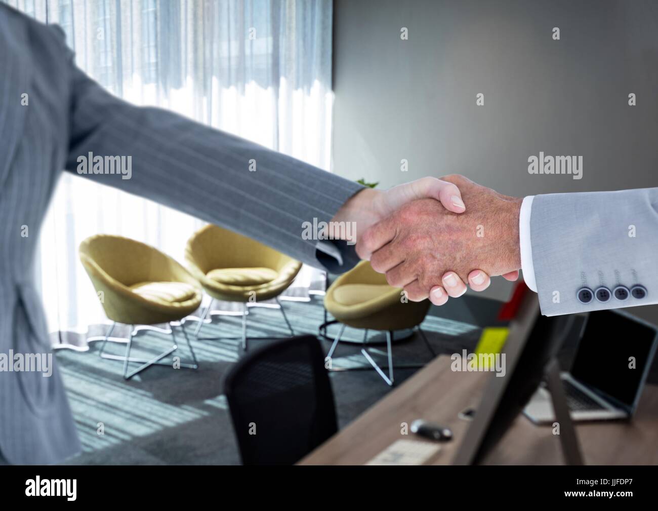 Digital composite of handshake in the desk of the office Stock Photo ...