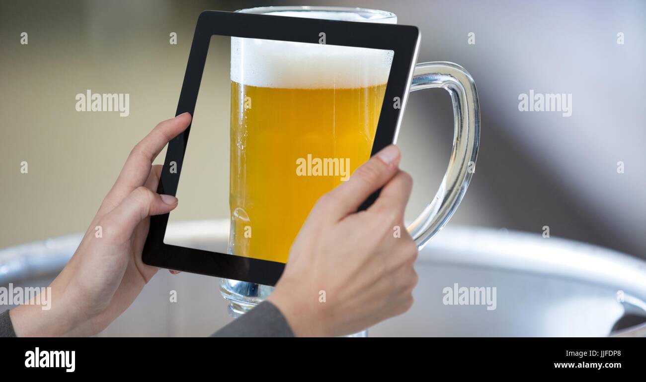 Digital composite of Hands photographing glass of beer through digital ...