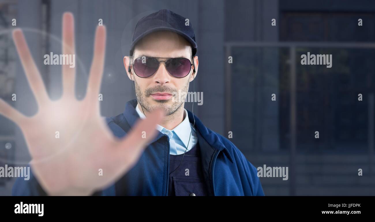 Digital composite of Security man outside blue background building with ...