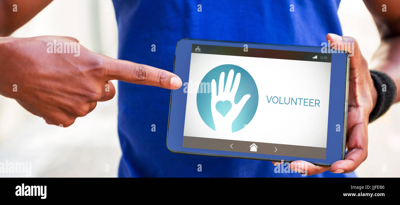 Volunteer text with icons on screen against man pointing at blank ...