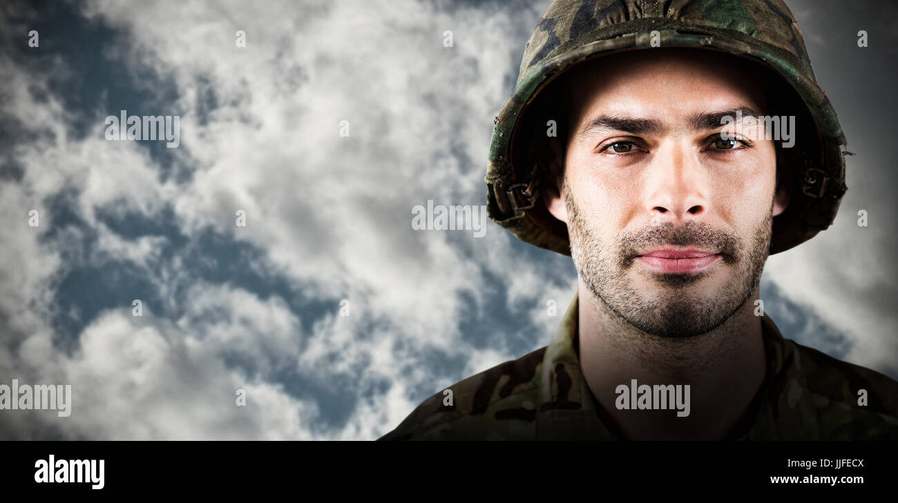 Close up of confident soldier wearing hard hat against full frame of ...