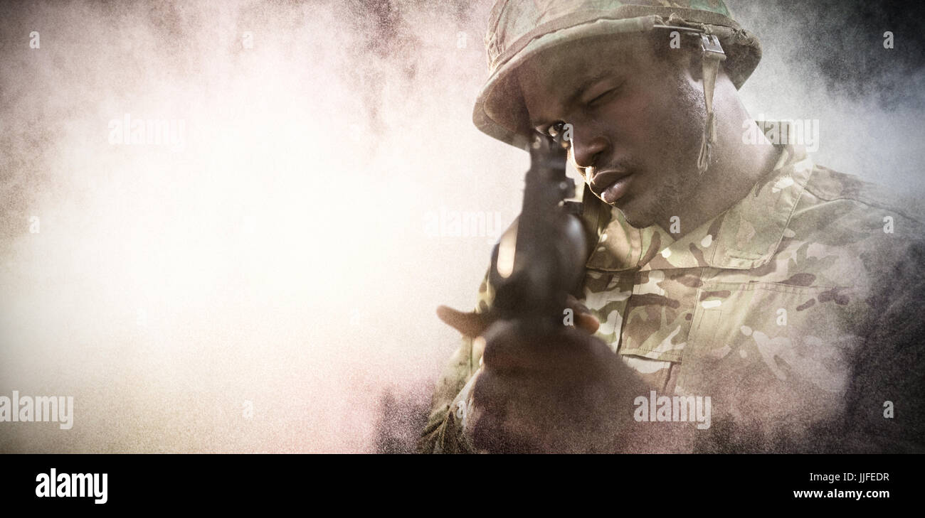 Close up of soldier aiming with rifle against black Stock Photo - Alamy