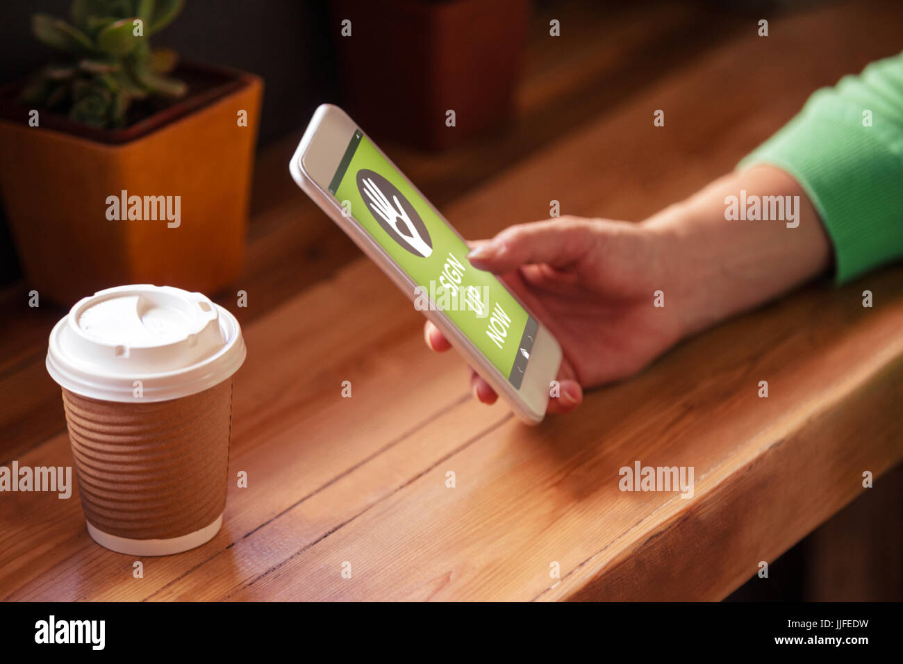Vector image of Sign Up Now text with icons against woman hand using ...