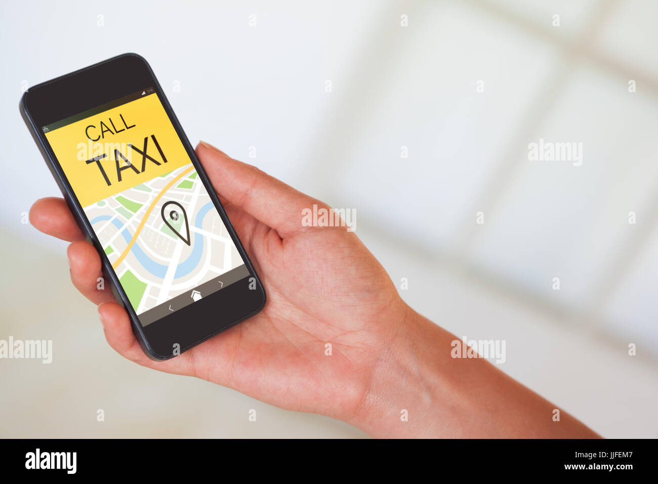 Womans hand holding black smartphone against vector image of call taxi ...