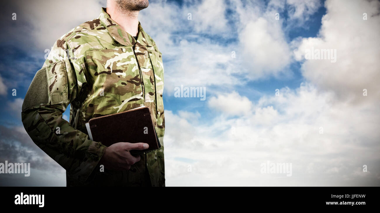 Mid section soldier holding books hi-res stock photography and images ...