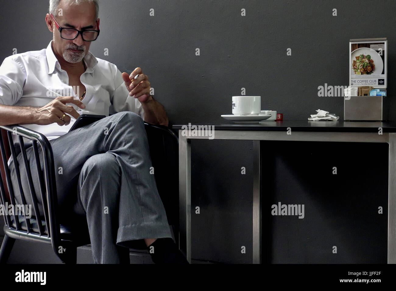 Man smoking cigarette drinking coffee hi-res stock photography and ...