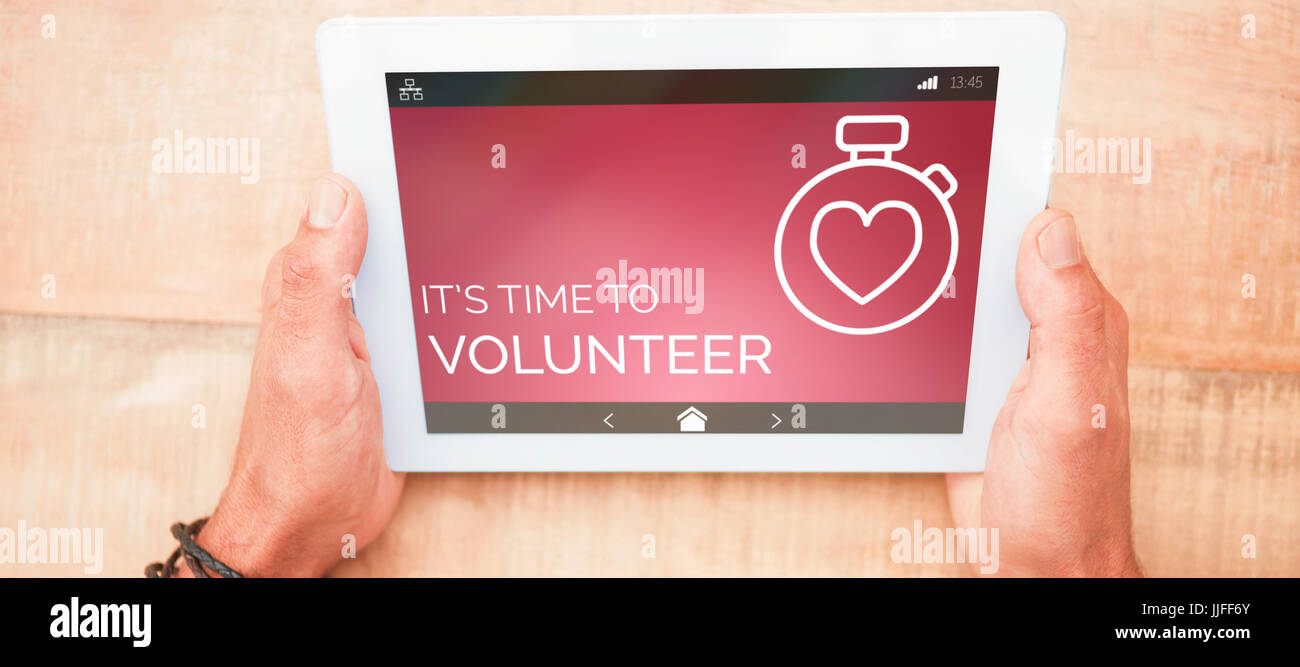 Volunteer text with icons on screen against hands holding blank screen ...