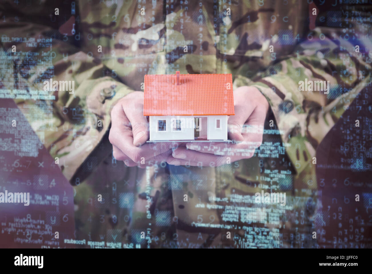 Mid section of soldier holding model home against abstract room Stock ...