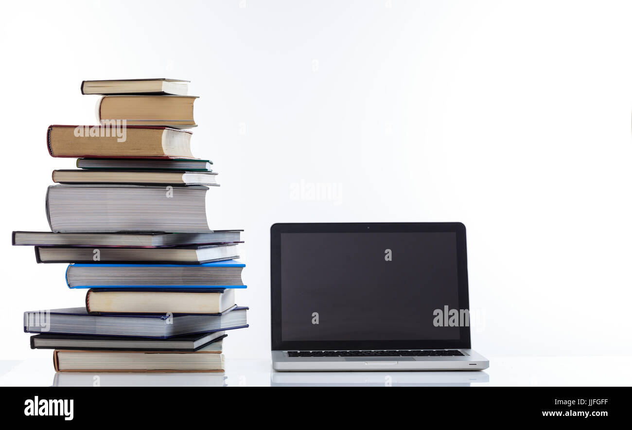 Education concept. Books stack and a laptop isolated on white background - copy space Stock ...