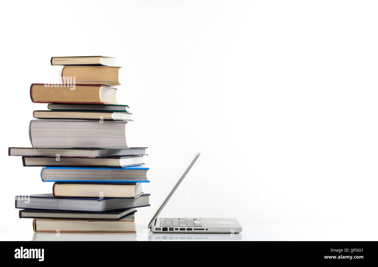Education concept. Books stack and a laptop isolated on white ...