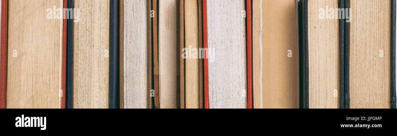 Old books in row close up texture - banner Stock Photo - Alamy
