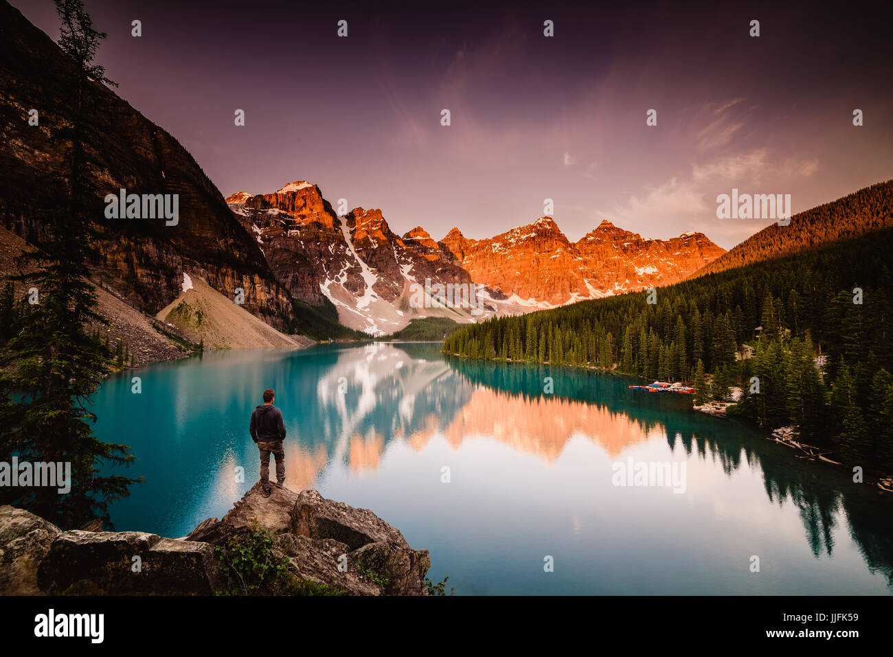 Man overlooking Moraine Lake at sunrise Stock Photo - Alamy