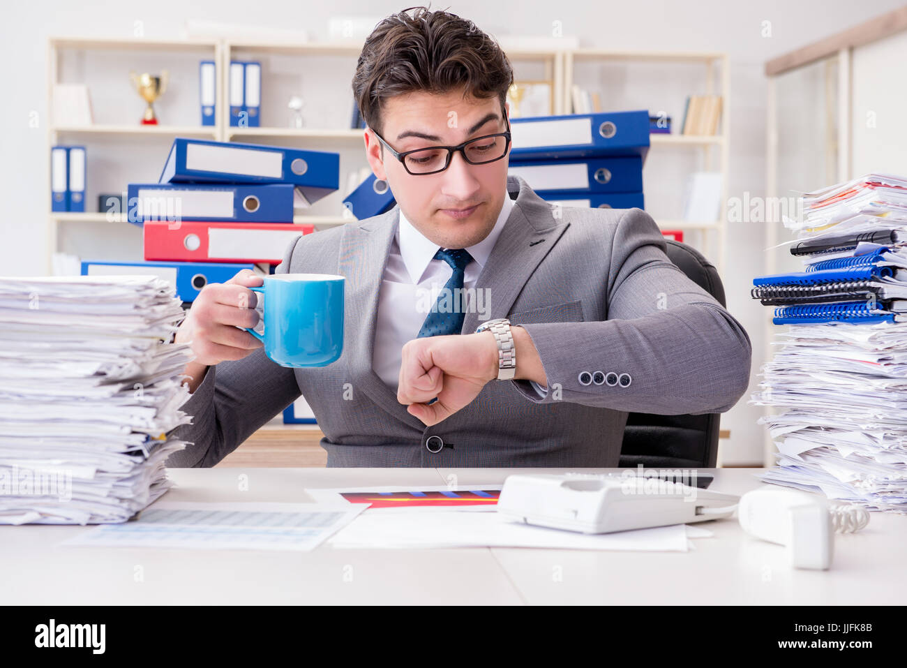 Businessman busy with much paperwork Stock Photo - Alamy