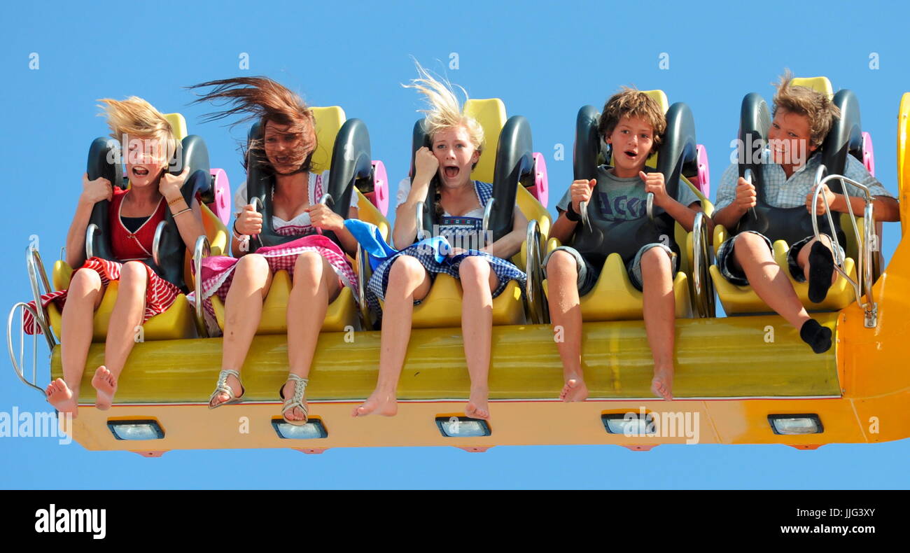Visitors ride a carnival ride at Oktoberfest on the Theresienwiese in ...
