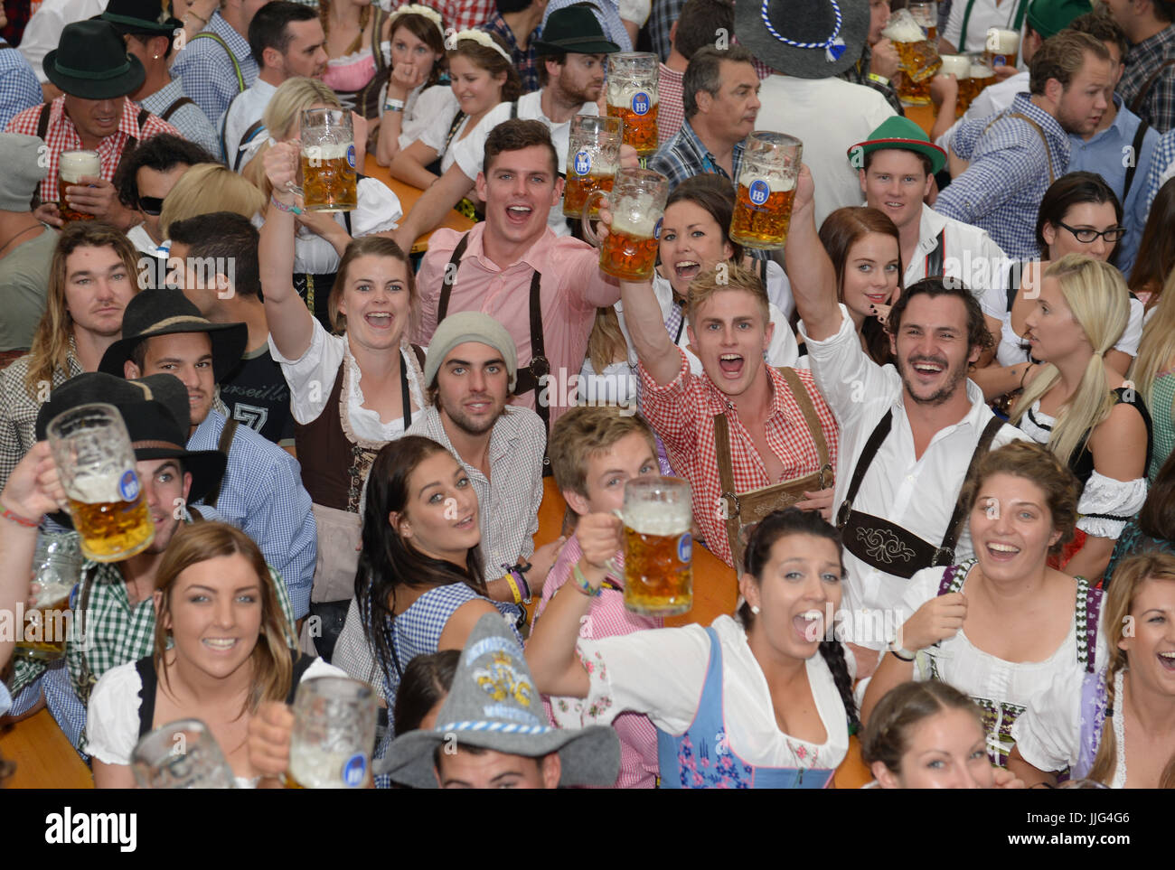 Guests celebrate at the Hofbraeu-beer tent at the Oktoberfest in Munich ...