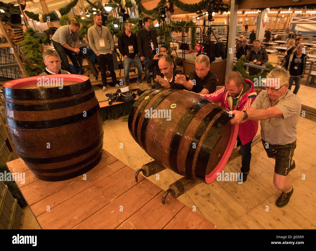 Brauhaus employees roll a 220-liter and 260-kilo wooden keg onto the ...