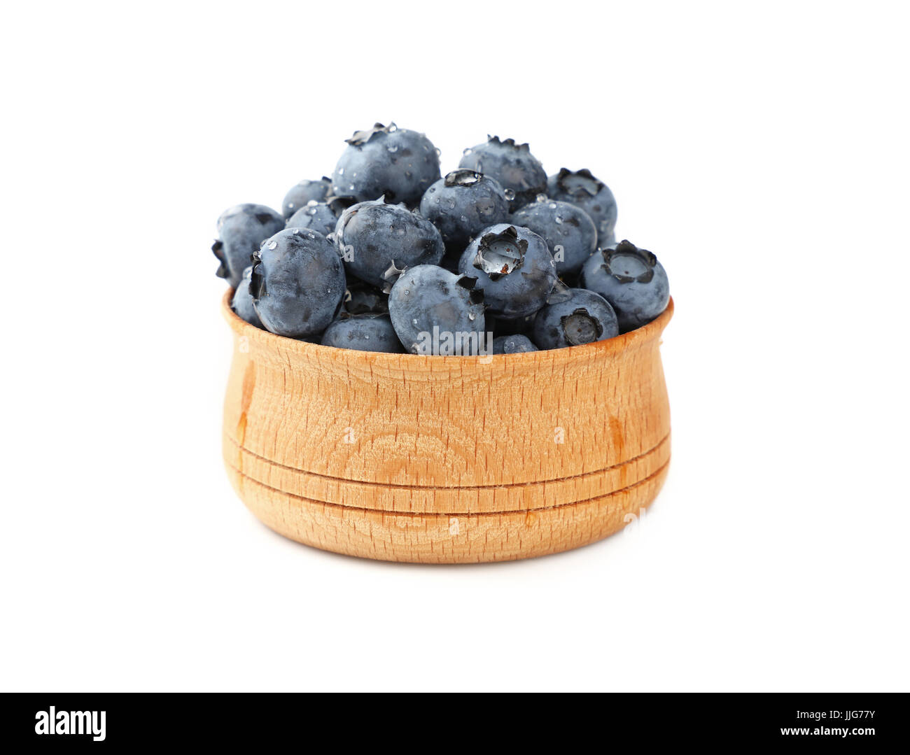 Portion of fresh washed blueberry berries in rustic wooden bowl, wet ...