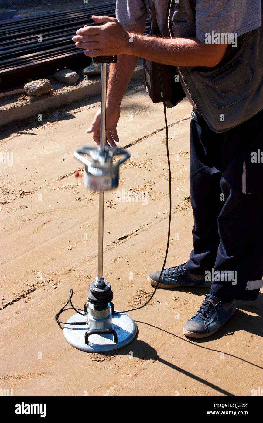 A road construction site: A worker using a transport engineering ...
