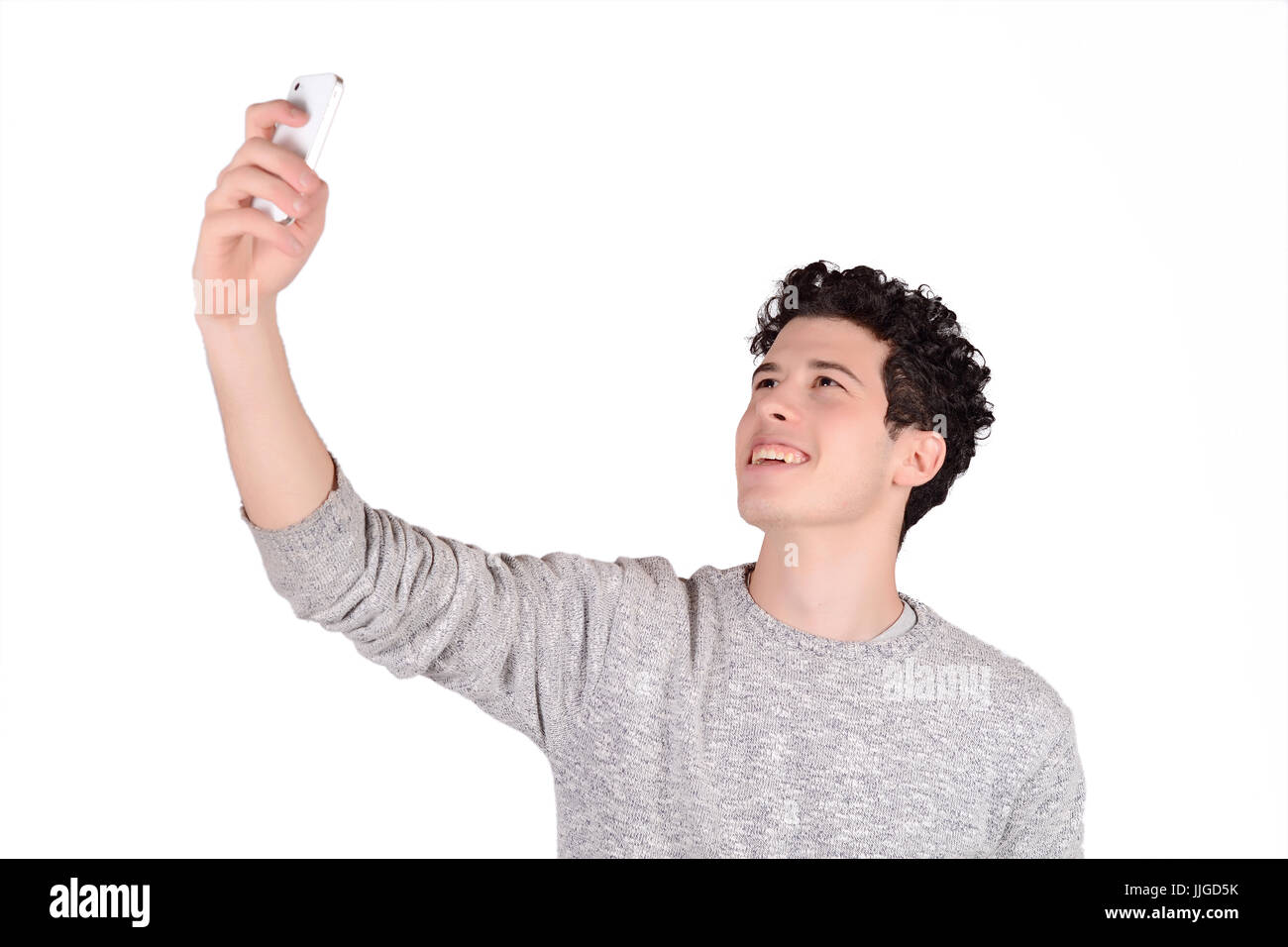 Portrait of a young man taking selfie with smartphone. Isolated white ...