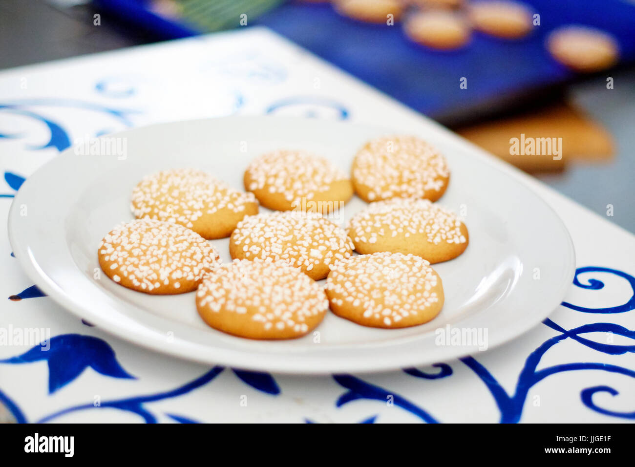 Light brown cookies with white sugar grains on a white plate Stock ...