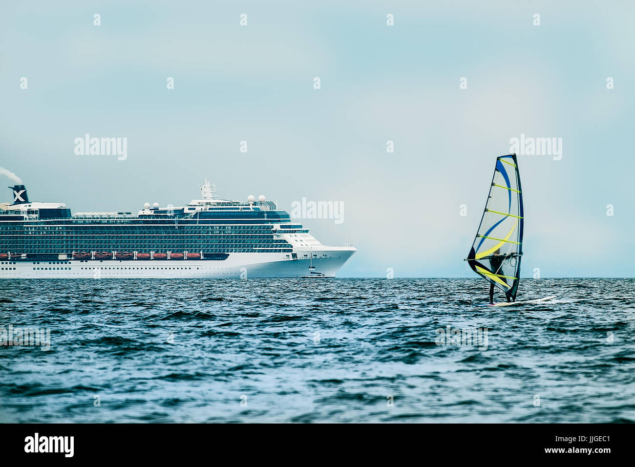 Windsurfer in the sea with cruise ship on backgroung Stock Photo - Alamy