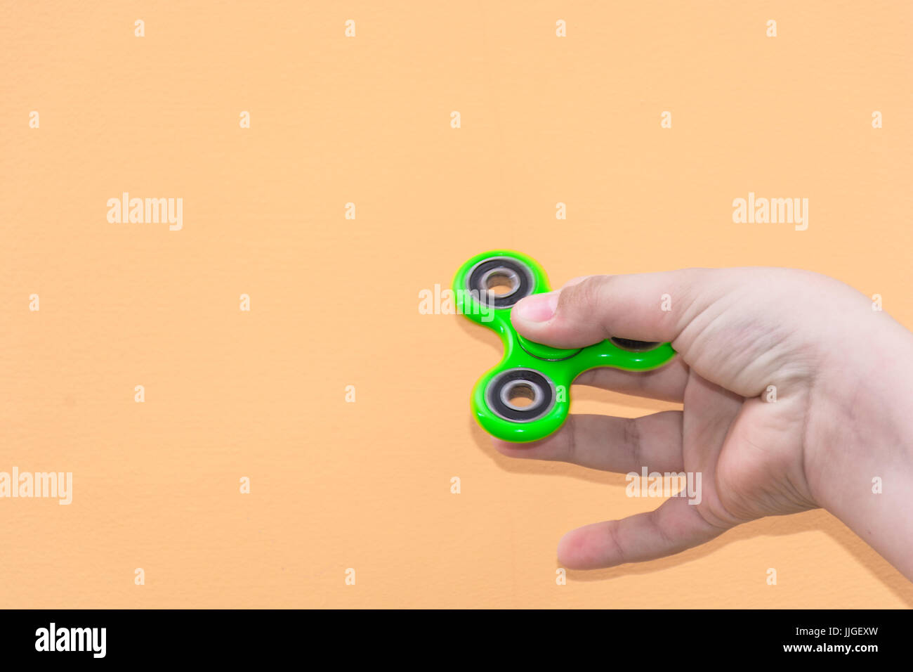 Boy playing with fidget spinner gadget. The fidget spinner is a toy, a ...
