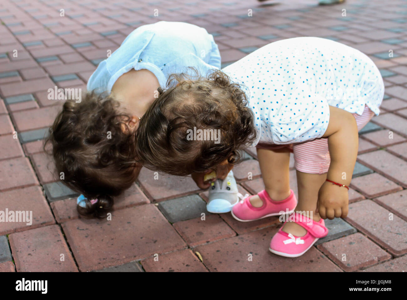 Sweet little girls playing with each other Stock Photo - Alamy