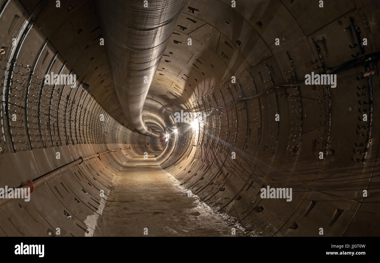 Empty subway tunnel under construction. Large temporary ventilation ...