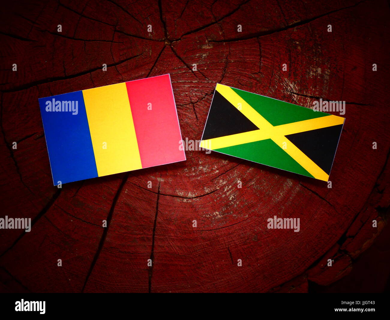 Chad flag with Jamaican flag on a tree stump isolated Stock Photo - Alamy