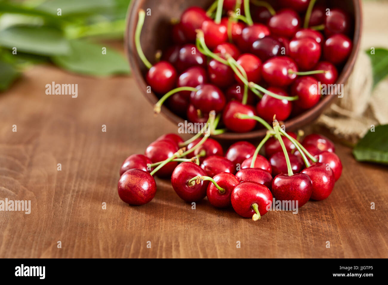 Cherries on wooden table with water drops macro background Stock Photo ...