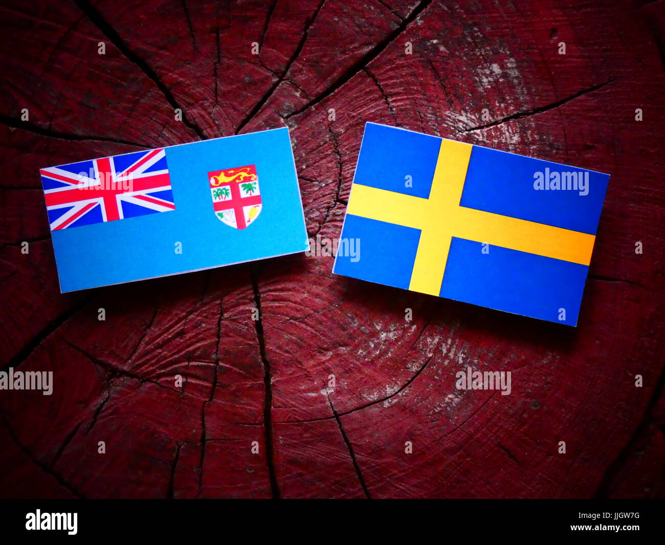Fijian flag with Swedish flag on a tree stump isolated Stock Photo - Alamy