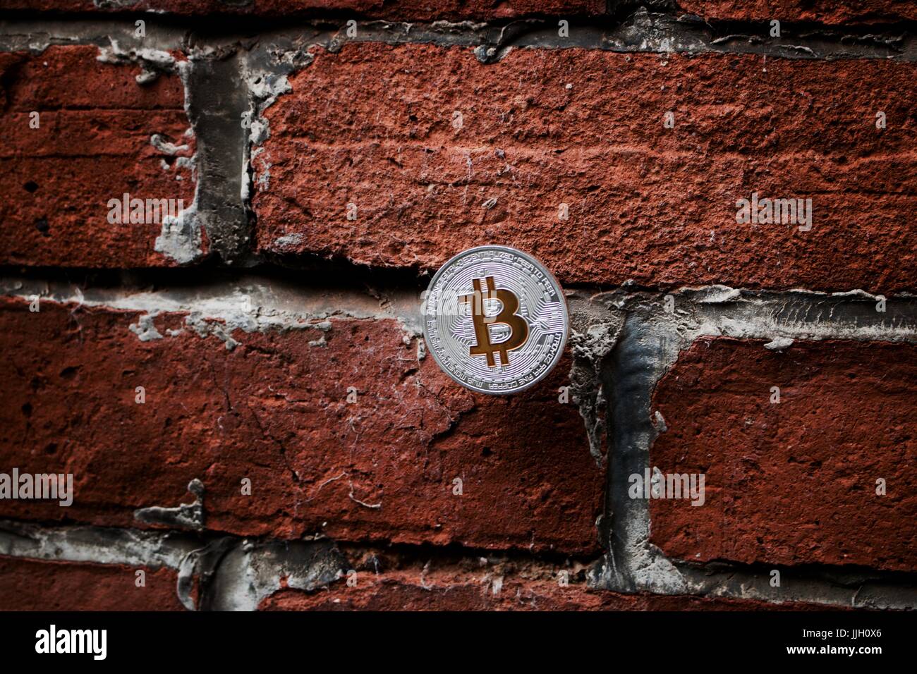 Cryptocurrency physical silver bitcoin coin with yellow sign on the ...