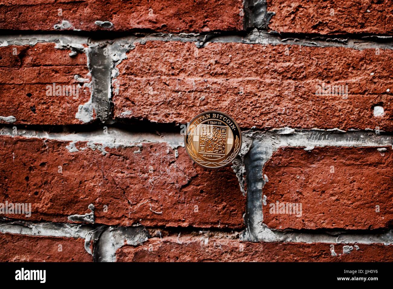Digital currency physical gold titan bitcoin coin on the brick wall ...