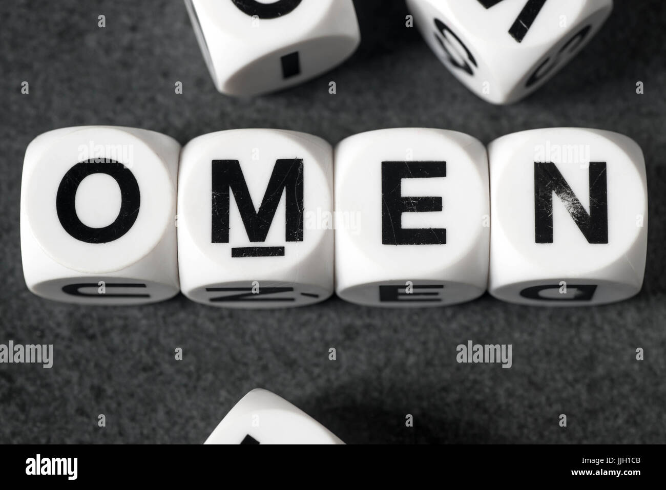 word omen on white toy cubes Stock Photo - Alamy
