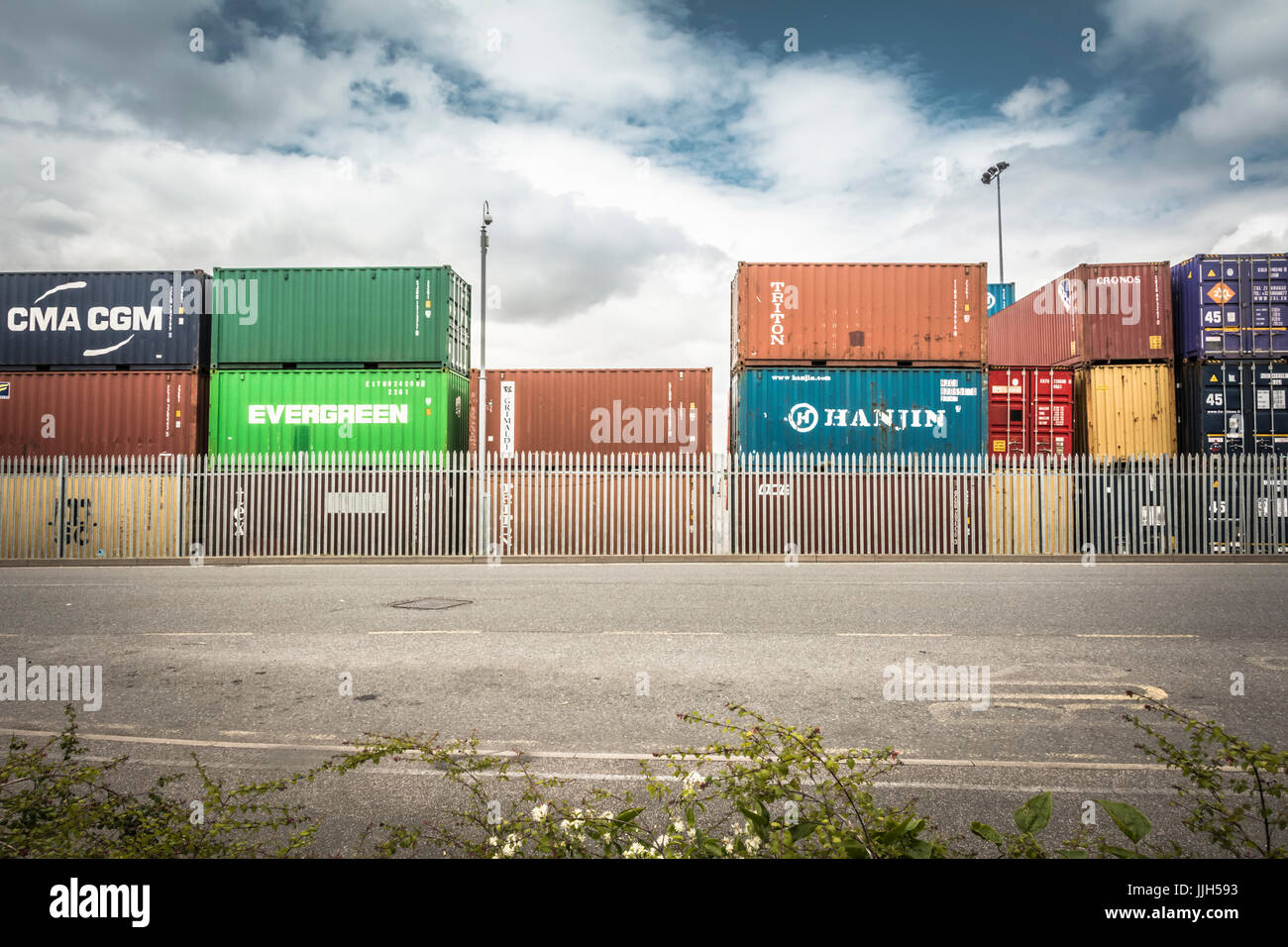 Colourful containers stacked at Tilbury Railport on the river Thames ...