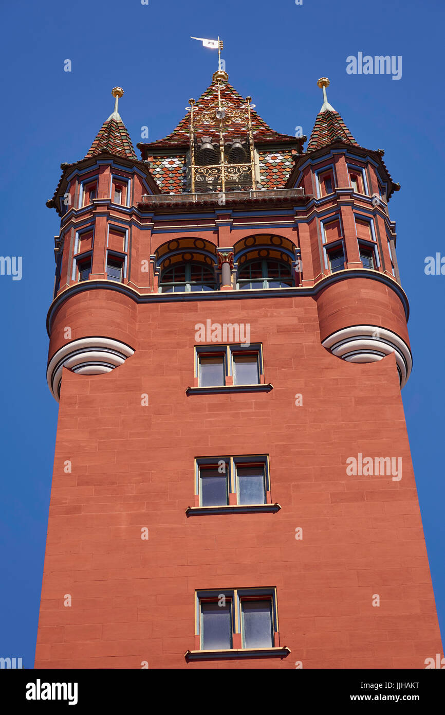 Tower of the red medieval Basel Town Hall ('Rathaus') with blue sky, in ...