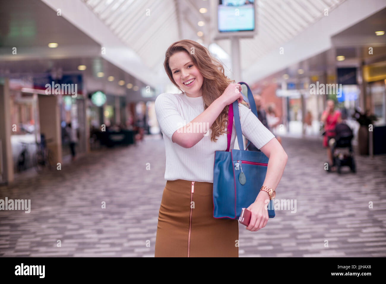 A young woman out shopping for the day Stock Photo - Alamy