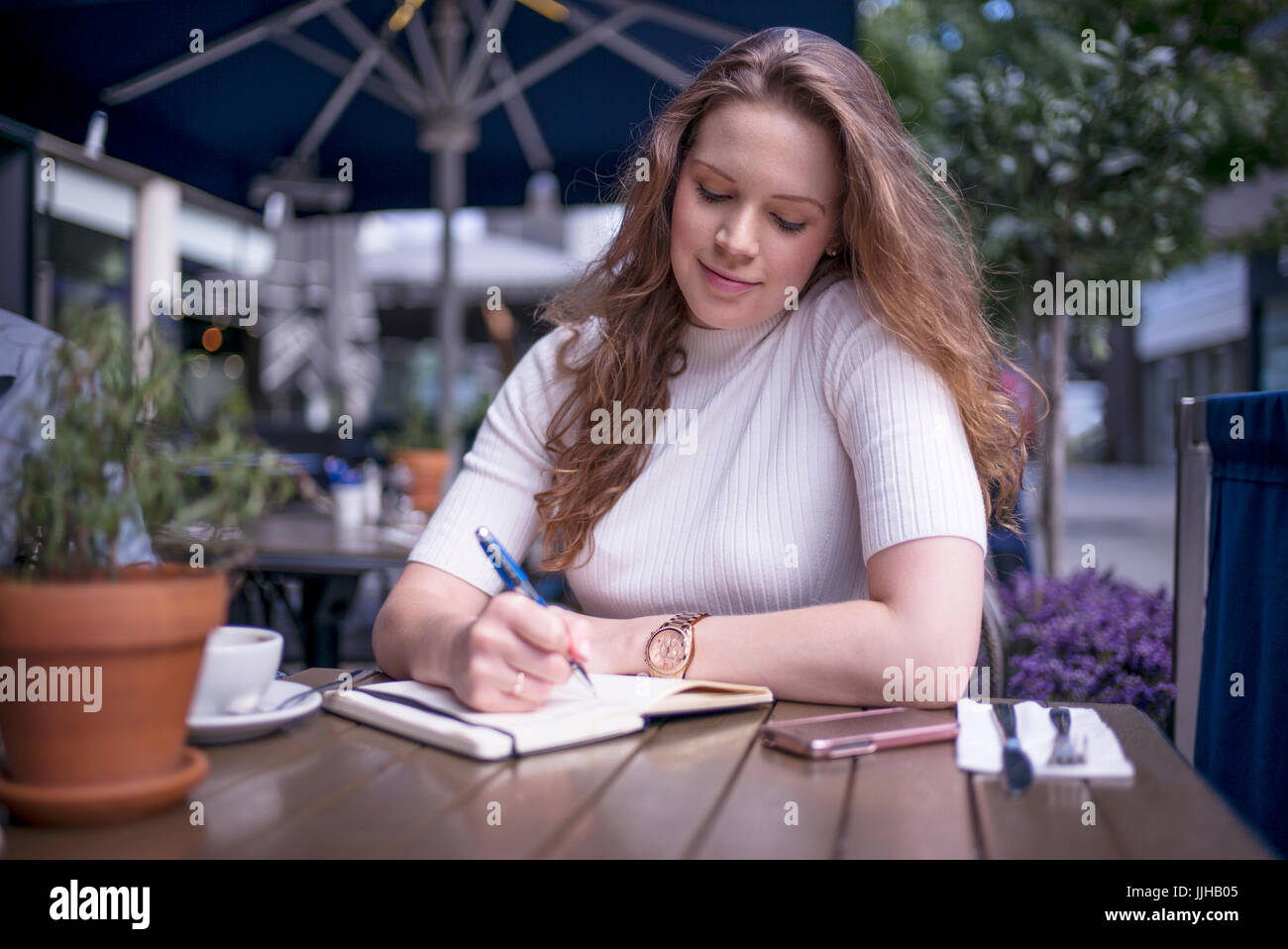 Woman sitting outside writing hi-res stock photography and images - Alamy