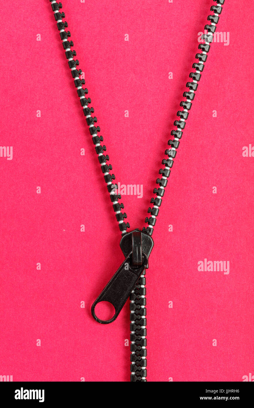 black plastic zipper with red background and copy space Stock Photo - Alamy