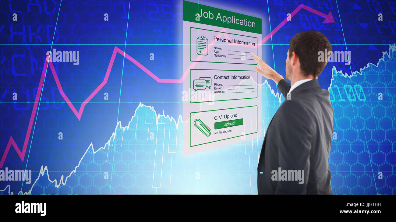 Focused businessman standing and pointing against stocks and shares ...