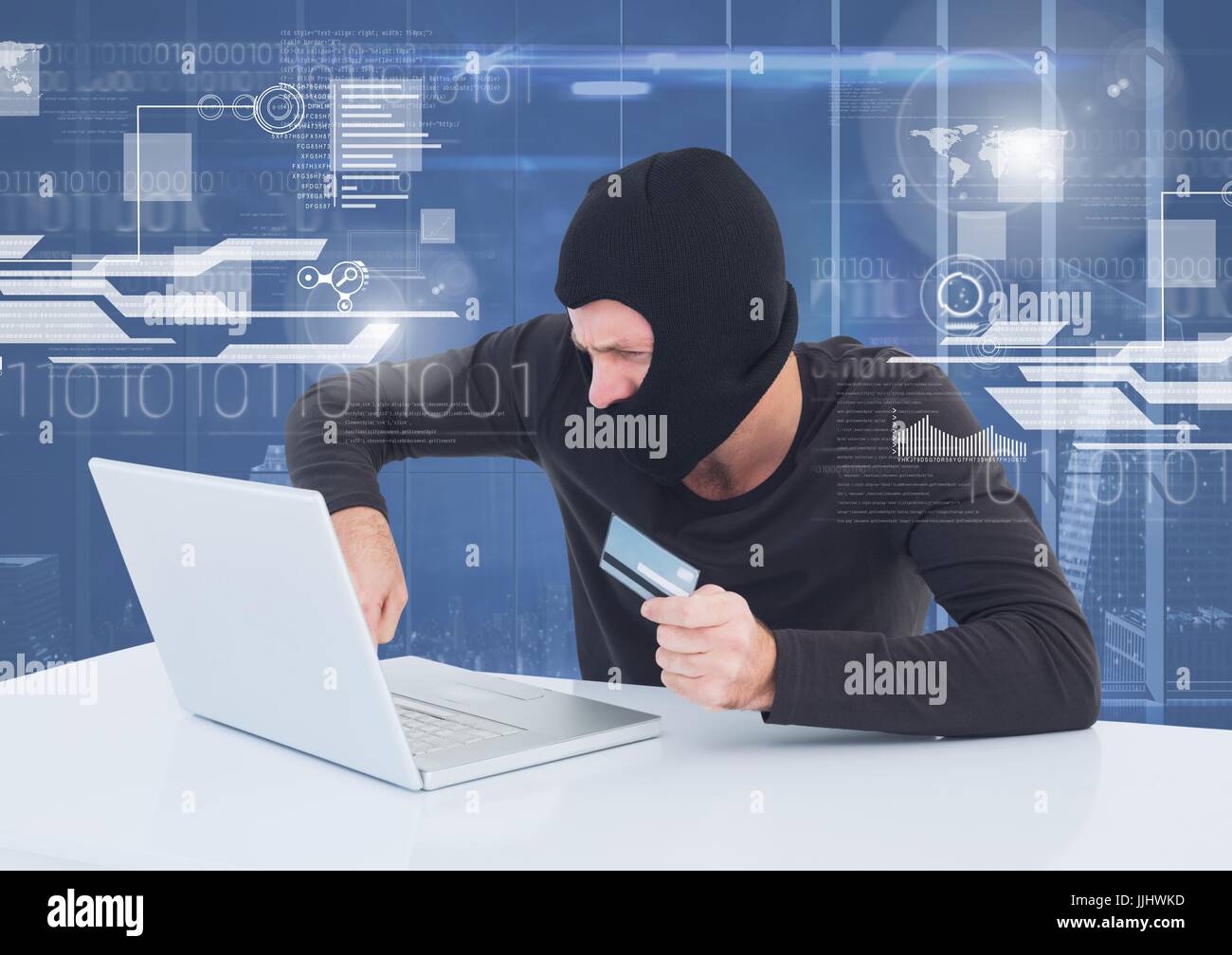 Hacker using a laptop and holding a credit card in front of 3D digital ...