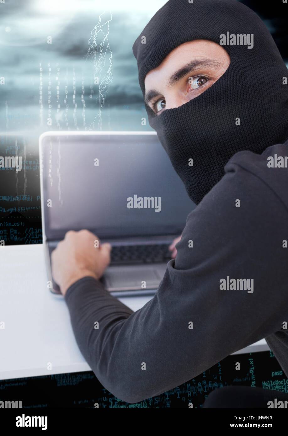 Hacker using a laptop and watching the lens Stock Photo - Alamy