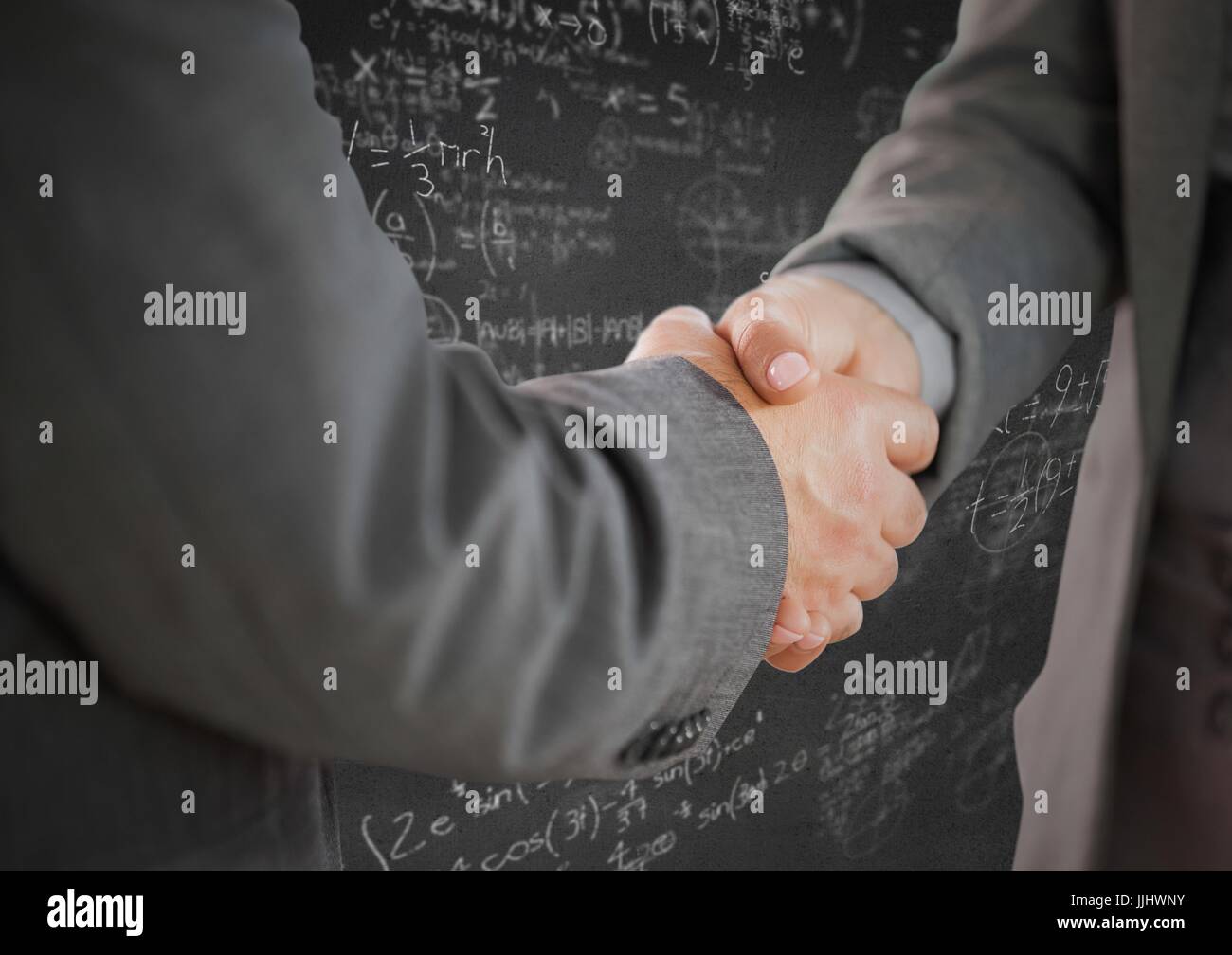 Handshake against grey wall with math doodles Stock Photo - Alamy